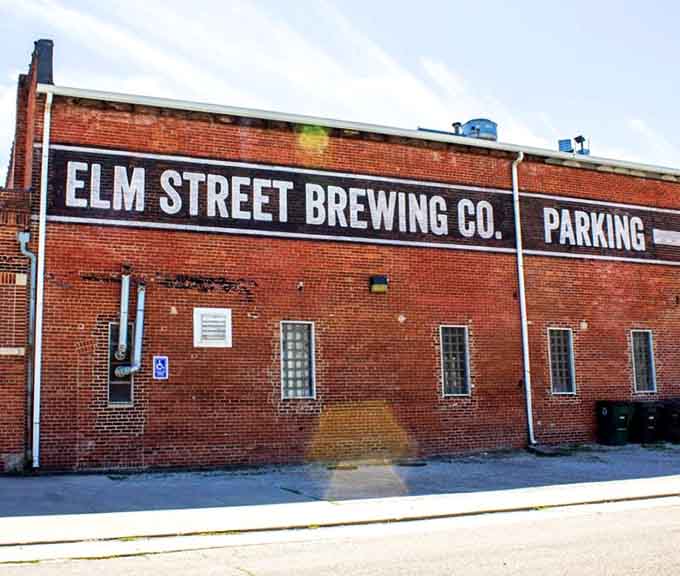Elm Street Brewing Company occupies industrial space where craft beer flows and community gathers naturally.
