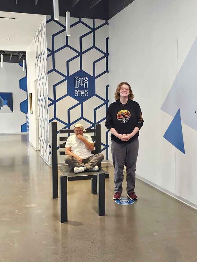 One person sits while another towers above, proving size really is just a matter of perspective here.