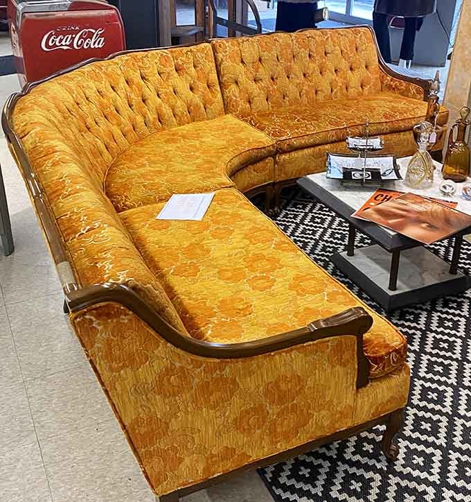 This golden sectional sofa screams 1970s louder than a disco ball at Studio 54 ever could.