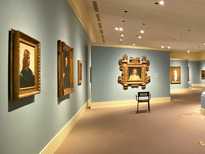 Ornate portraits line these serene blue walls, where golden frames hold centuries of stories and secrets.