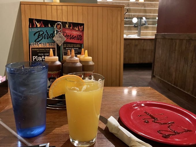 Bright beverages and barbecue sauce bottles standing ready like soldiers awaiting their delicious deployment into action.