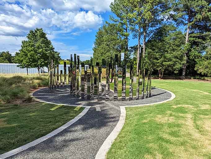 Mirrored columns create an outdoor installation that's part art, part optical illusion, and completely mesmerizing to walk through.