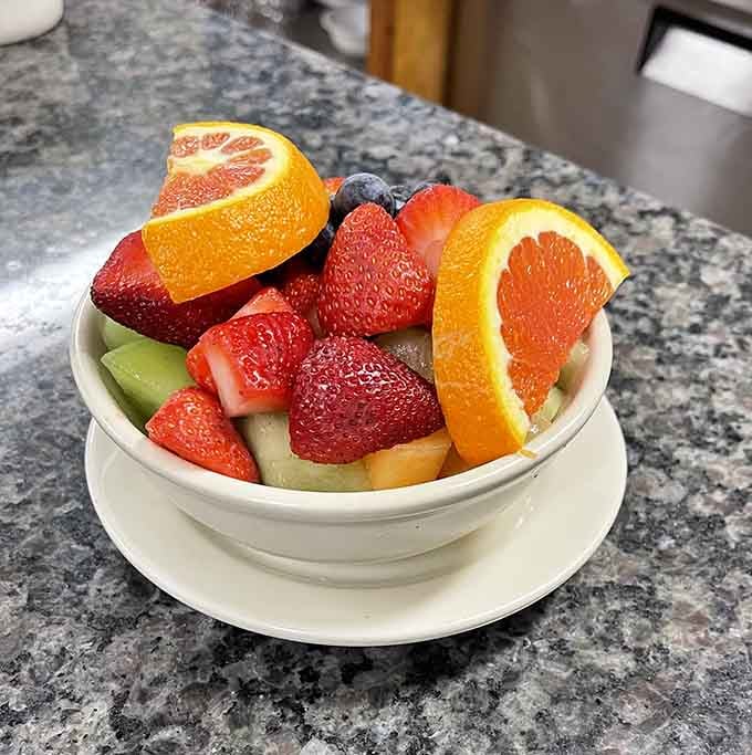 Fresh fruit arranged like edible art, offering a lighter path for those intimidated by pancake enormity.