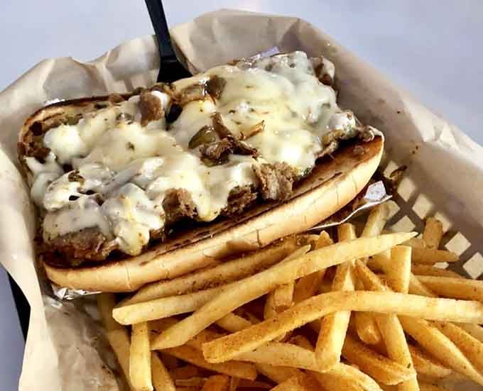 Melted cheese cascades over grilled steak and peppers, transforming the classic Philly into burger form beautifully.