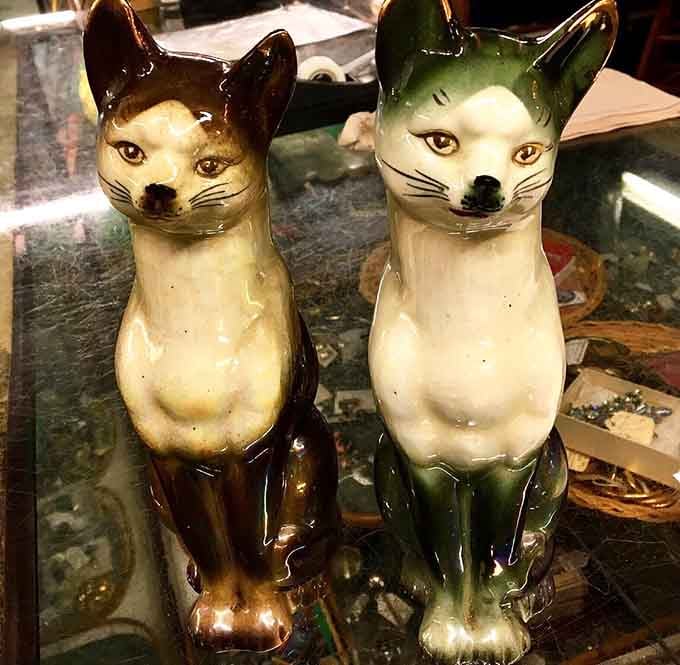 These ceramic cats have seen some things, and they're judging your decorating choices with those knowing eyes.