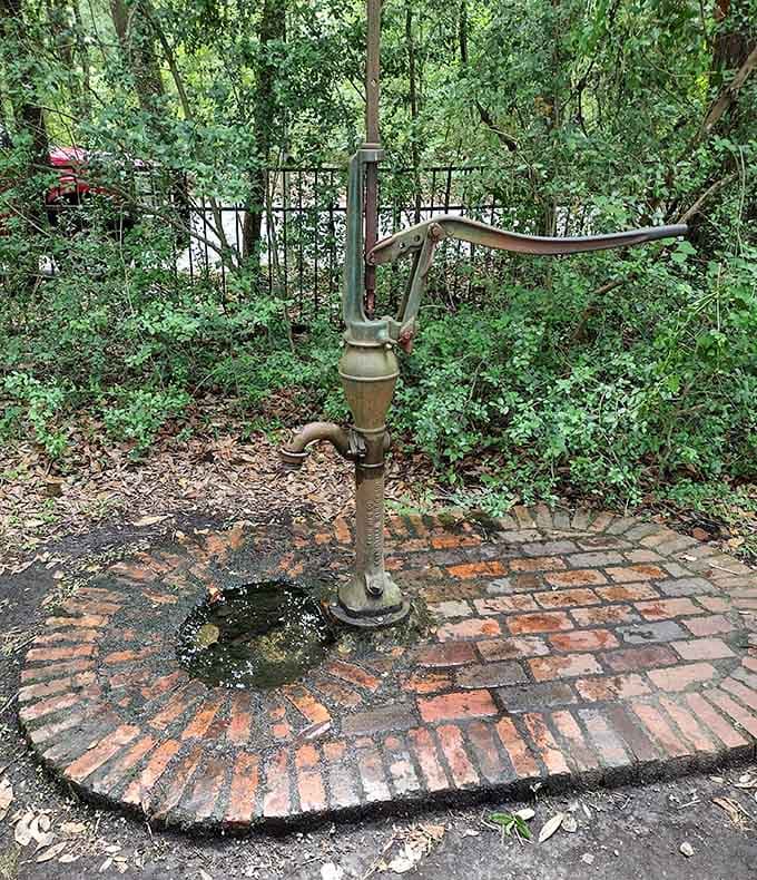 An old water pump reminds visitors that even sacred spaces needed practical plumbing back then.