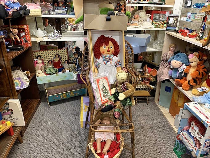 Raggedy Ann presides over this toy kingdom like a benevolent queen watching over her slightly chaotic vintage subjects.