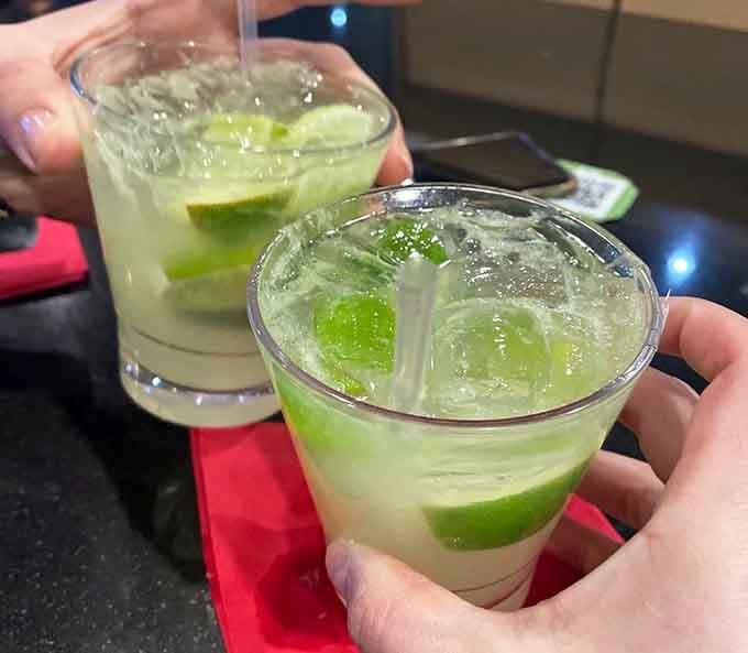 Caipirinhas clinking together in a toast to making excellent life choices that involve unlimited Brazilian barbecue tonight.