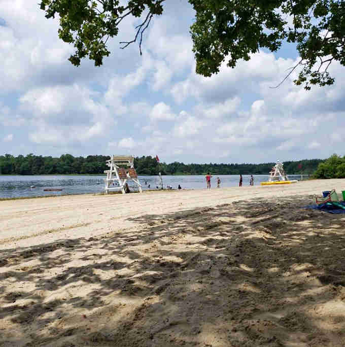 A sandy beach with lifeguard stands proves that lakes can compete with oceans for summer fun supremacy.