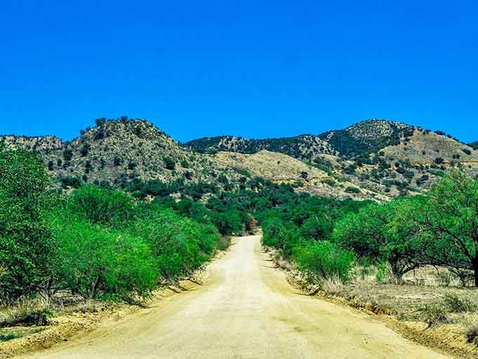 Dirt roads wind through green valleys toward distant peaks, offering the kind of scenery that makes cameras weep.