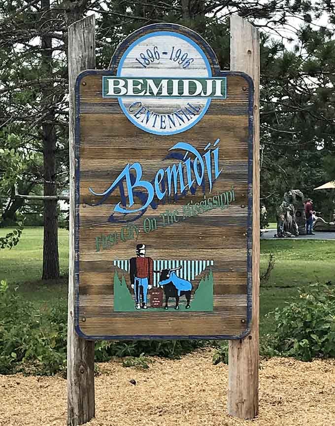 The weathered Centennial sign shows Paul and Babe in miniature, proving good design never goes out of style.