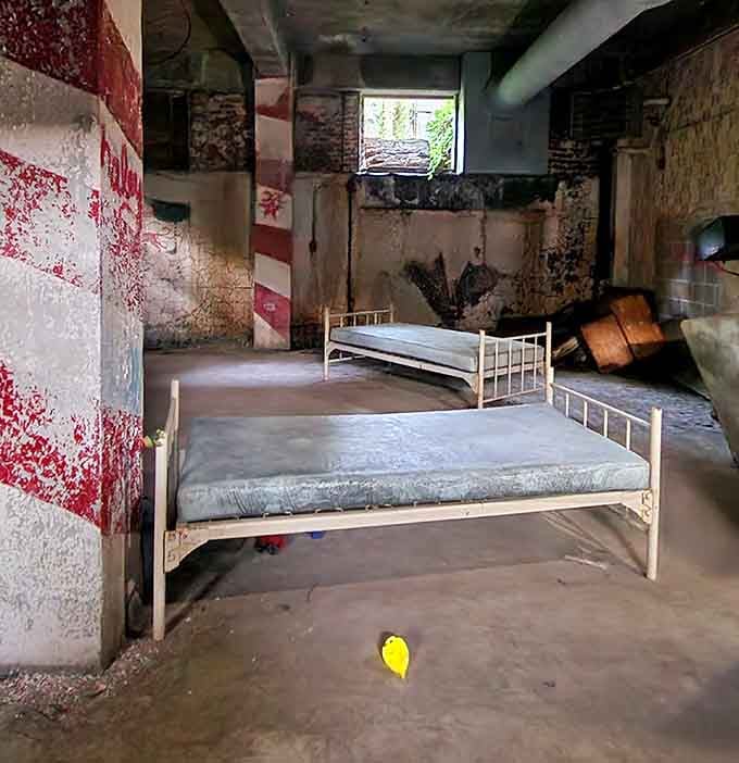 Those metal bed frames tell silent stories of the thousands who once called this institutional space home.