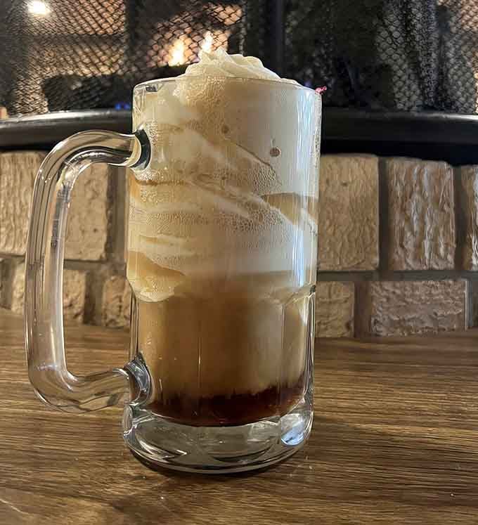 Root beer float topped with enough foam to make you grin like a kid on summer vacation.