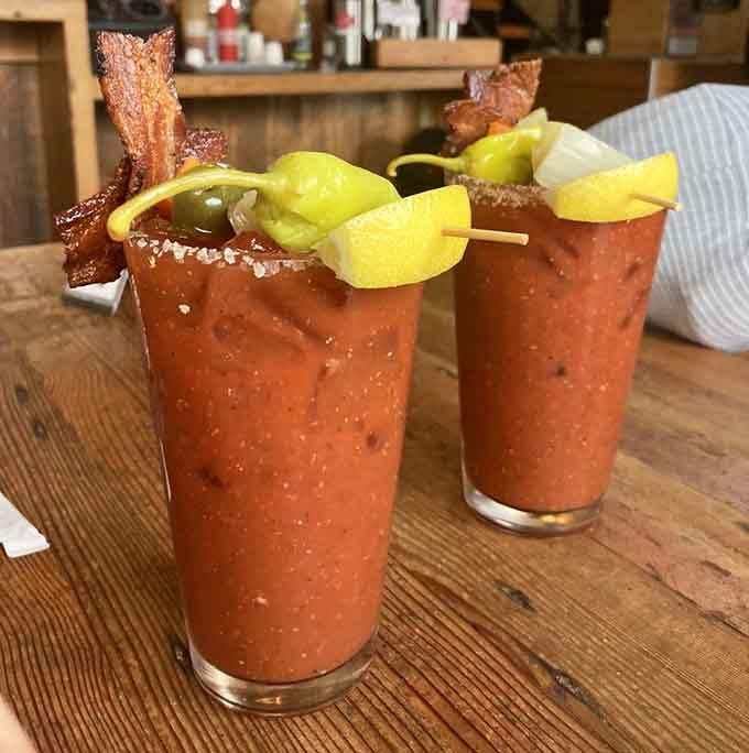 Bloody Marys garnished with bacon because if you're going big on breakfast, why stop at the plate?