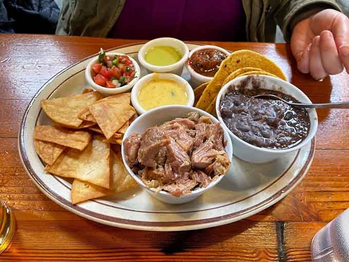 The Plato Tejano brings together pulled pork, beans, chips, and salsas in one glorious Tex-Mex celebration.