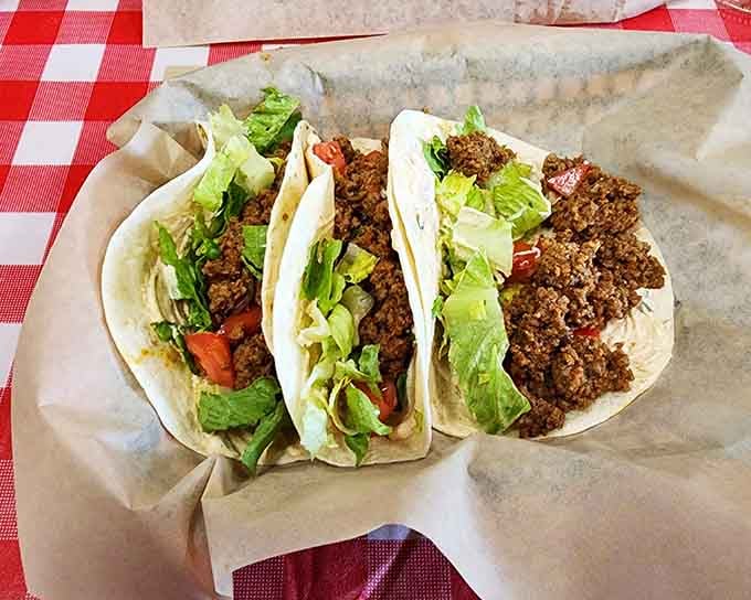 Three perfectly assembled tacos lined up like delicious soldiers ready to march straight into your happy place.