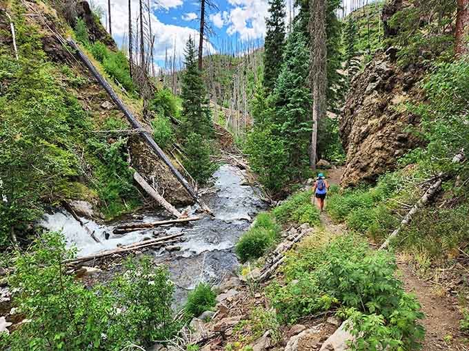 The trail winds alongside rushing water, promising thermal rewards for those willing to earn their relaxation the old-fashioned way.