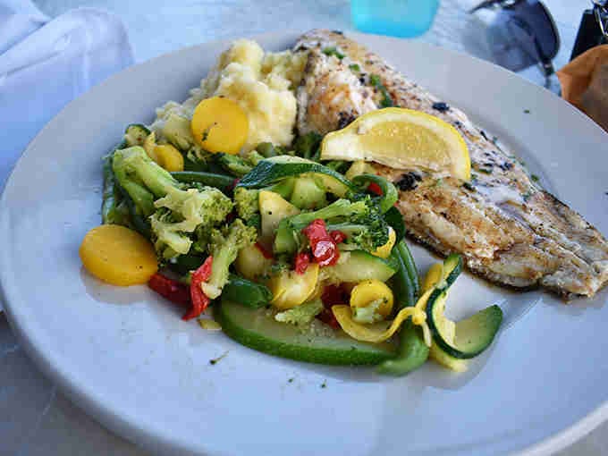 Fresh fish, colorful vegetables, and mashed potatoes proving that healthy eating doesn't have to look boring or taste bland.