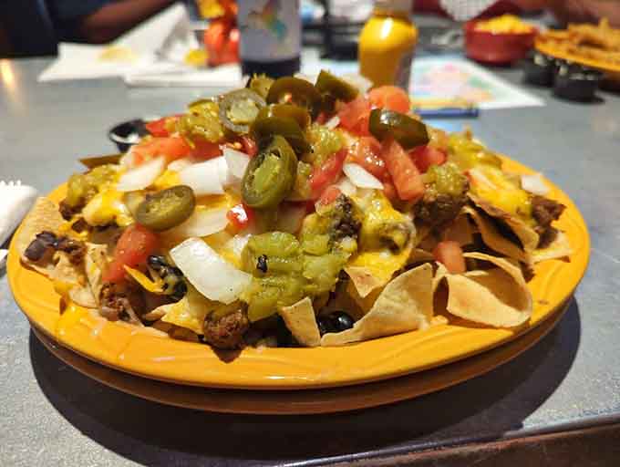 Nachos piled high with all the fixings, proving that sometimes more really is more, especially with jalape&ntilde;os involved.