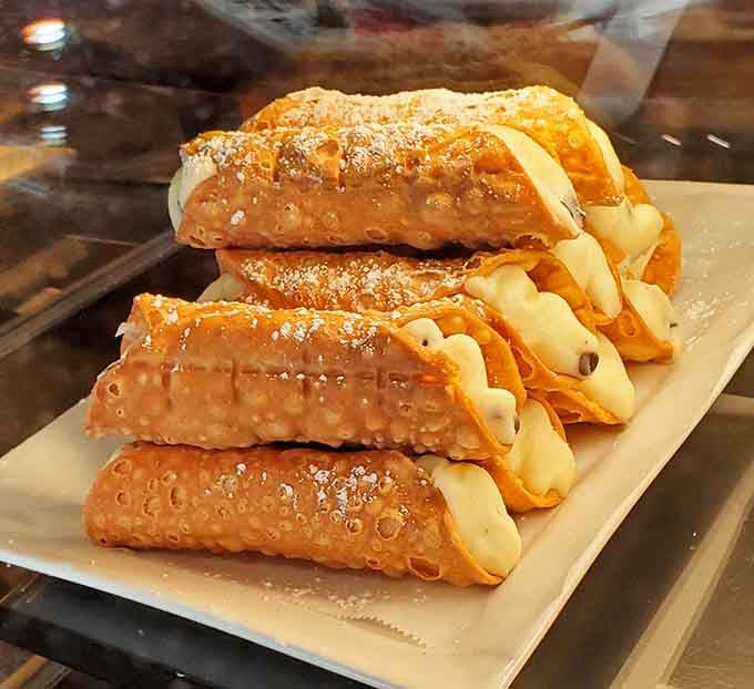Those aren't just cannoli; they're little tubes of happiness dusted with powdered sugar and filled with dreams.