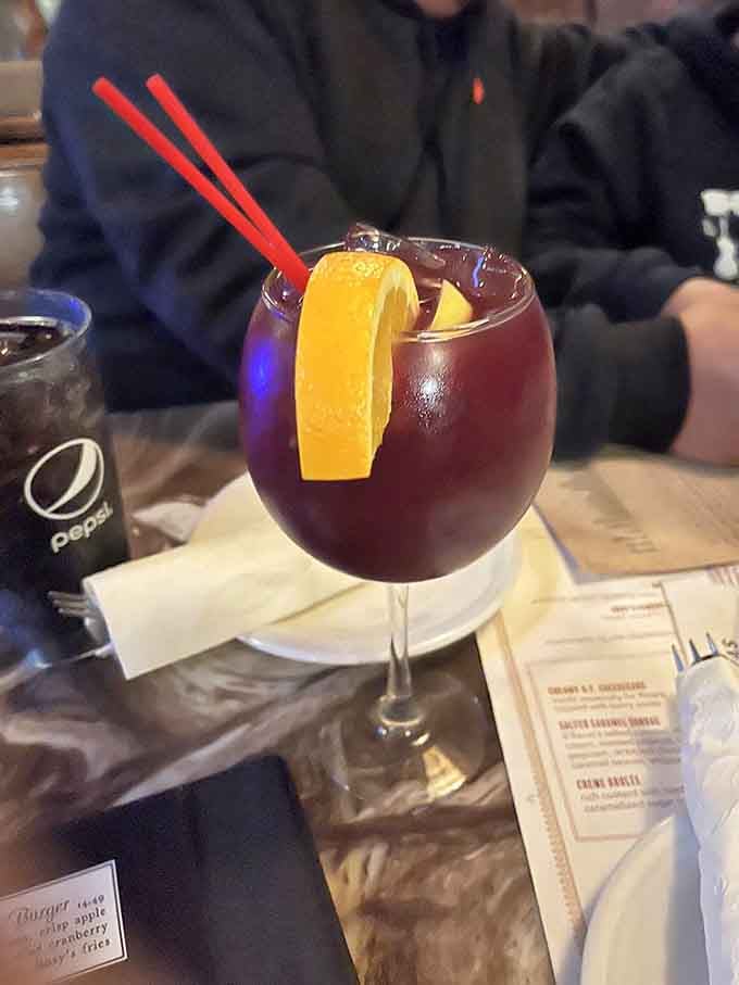 Red sangria garnished with orange, because even your beverage deserves to look as good as it tastes here.