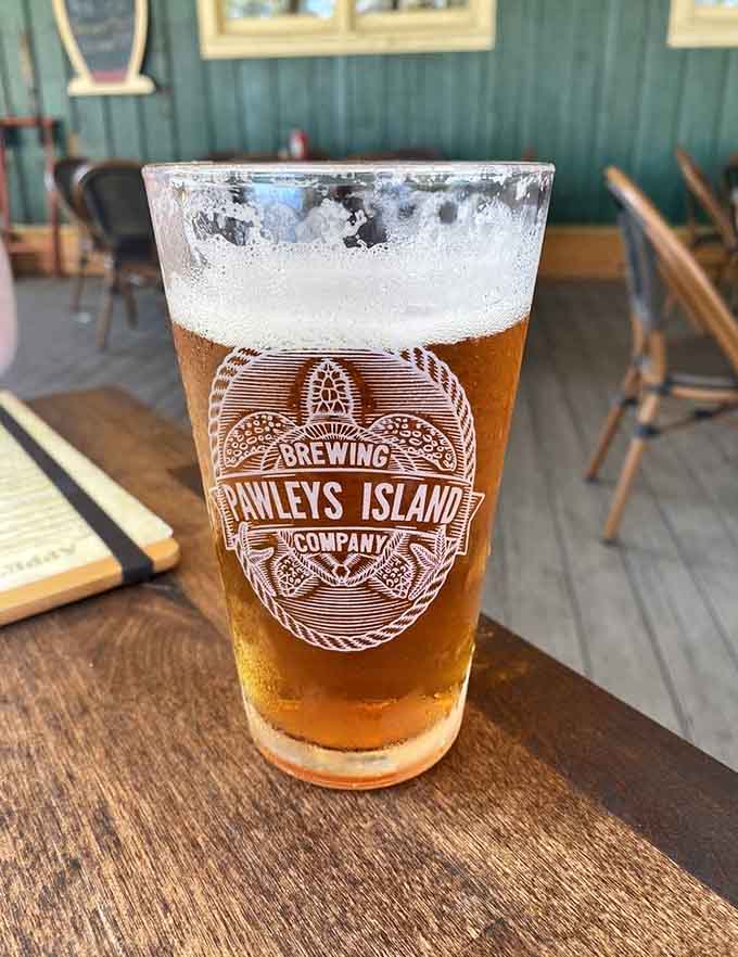 A cold local brew with condensation running down the glass, the perfect companion for waterfront dining on a warm day.