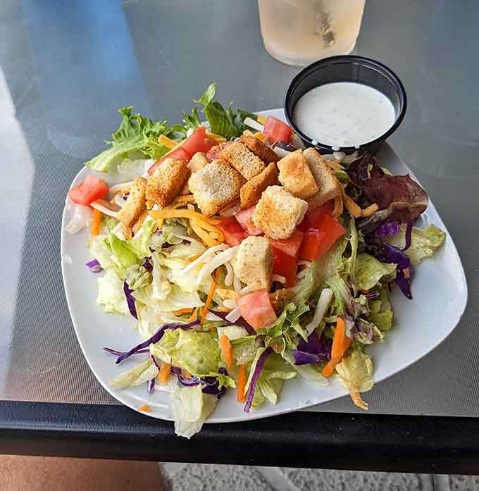 Fresh greens topped with golden croutons and colorful vegetables prove that even the lighter options get serious attention here.
