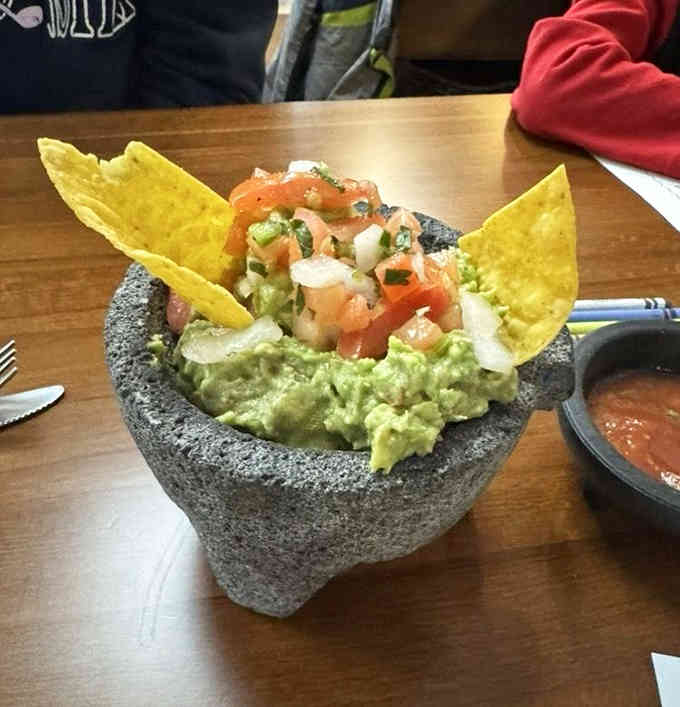 Fresh guacamole served in a molcajete, the way nature and your taste buds always intended it.
