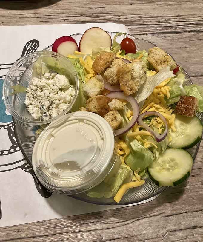 Fresh salad with breaded delights proves that even seafood restaurants understand the importance of greens and balance.