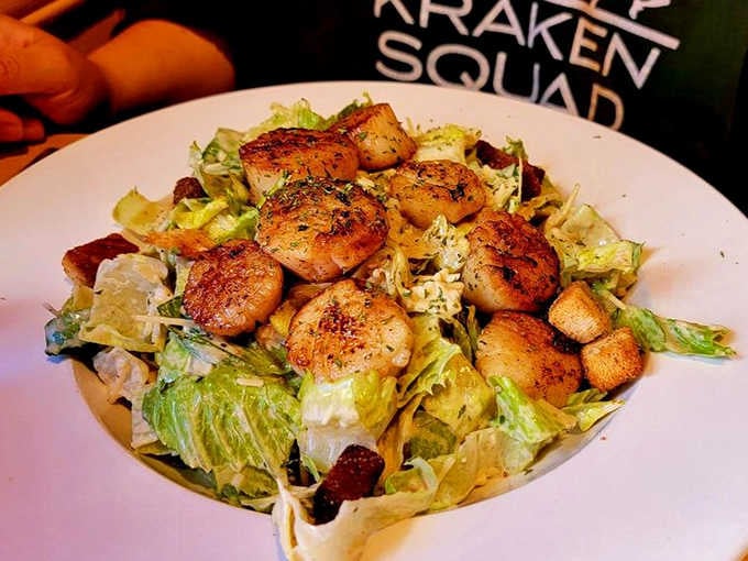 Perfectly seared scallops crowning a bed of greens, making healthy eating look like the best decision you've made.