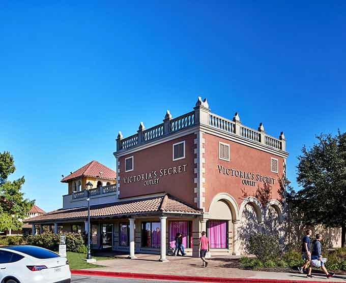 Victoria's Secret rises like a pink palace, complete with ornate details that elevate the outlet experience.