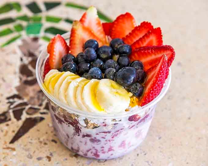 Fresh berries and granola in a bowl that's basically breakfast pretending to be virtuous and succeeding.