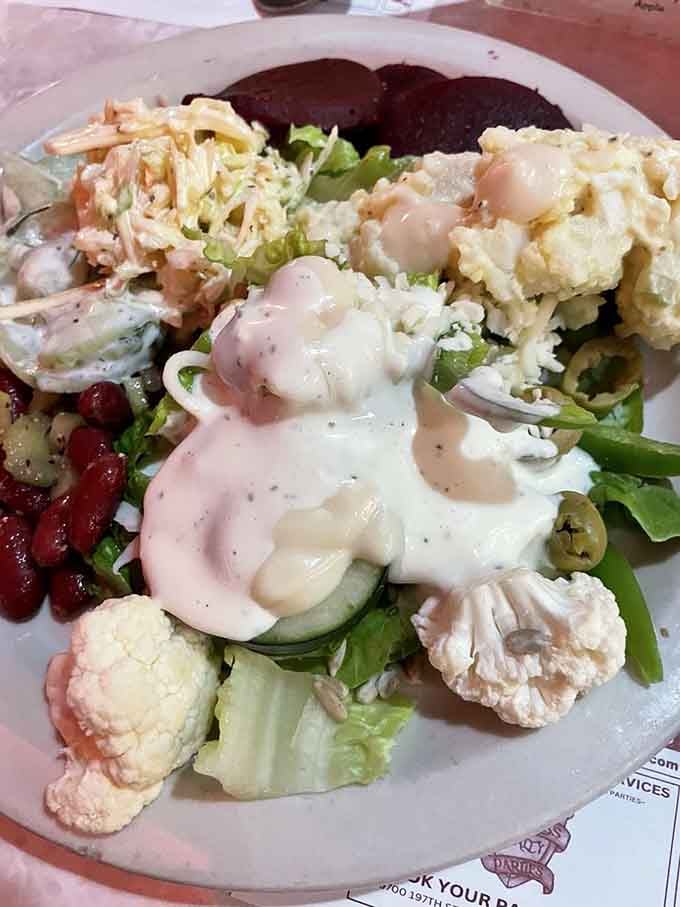 Fresh salad bar offerings provide the illusion of balance before you inevitably return for more carbs and meat.
