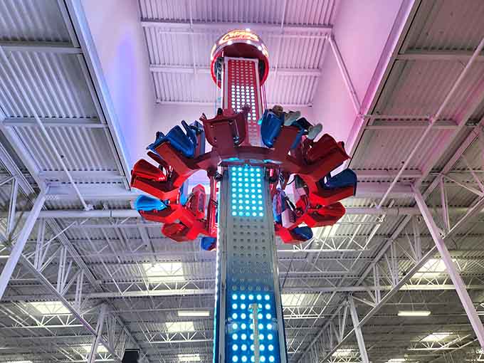 The drop tower looms overhead like a colorful dare, testing courage one stomach-dropping moment at a time.