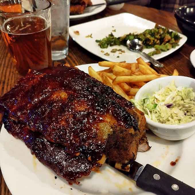 Ribs glazed to mahogany perfection, the kind that require both hands and zero shame about the mess.