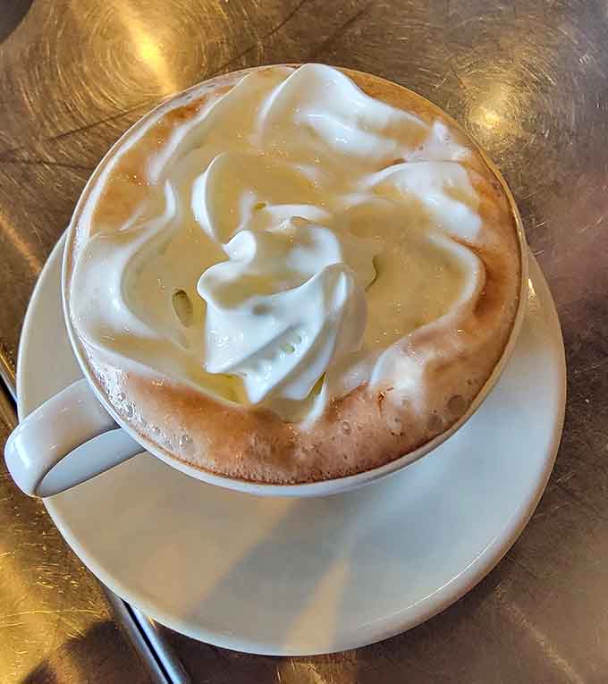 Hot chocolate topped with whipped cream that could double as a winter hat for very small people.
