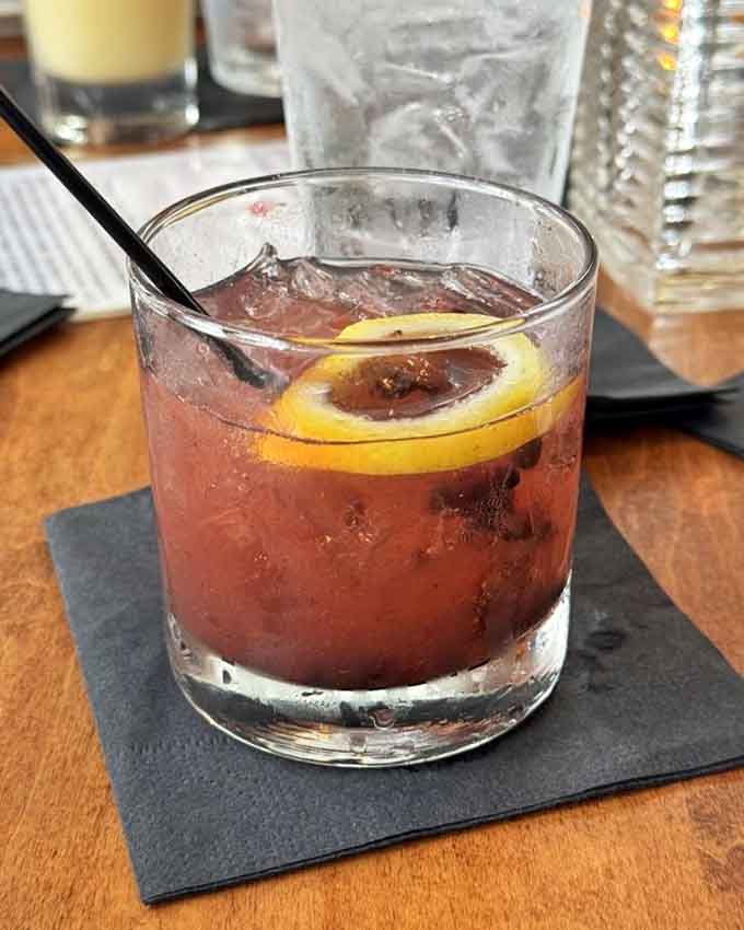 A perfectly crafted cocktail with a citrus twist makes watching the harbor even more enjoyable than it already is.