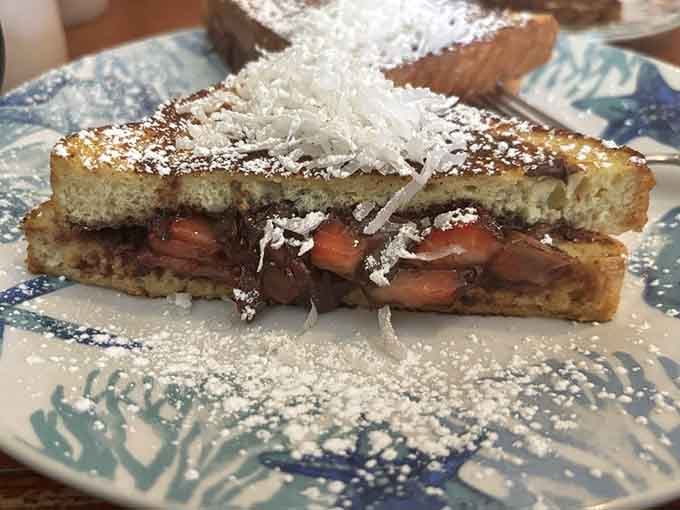 Nutella and strawberries between French toast proves that some sandwiches are actually dessert in disguise, brilliantly.