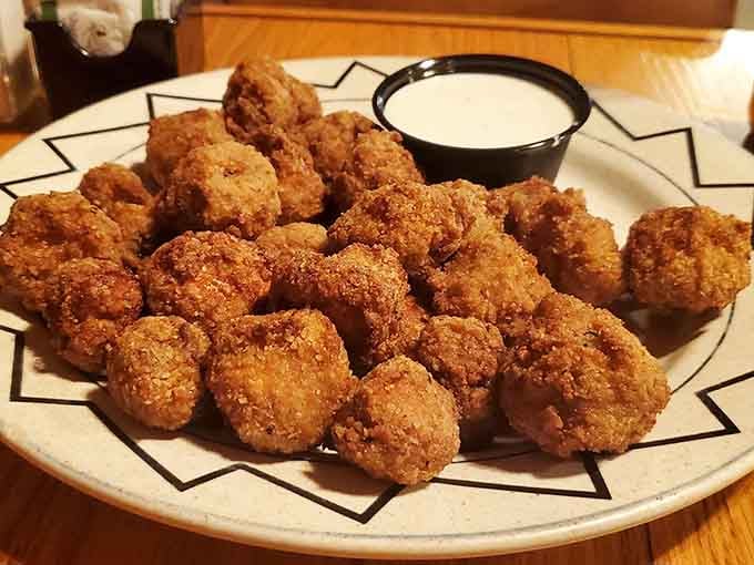 Golden-fried mushrooms arrive crispy and hot, perfect for those who believe vegetables count when they're this delicious.