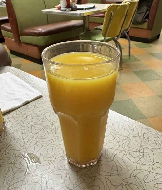 Fresh orange juice in a proper glass because some traditions are worth keeping, even in our disposable world.