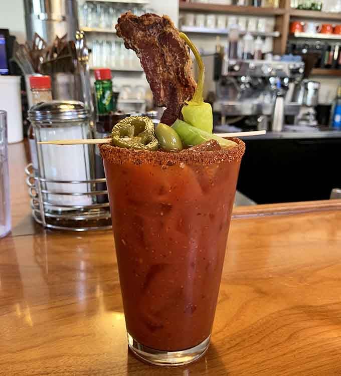 That bacon strip standing at attention in a Bloody Mary is basically the breakfast equivalent of planting a flag.