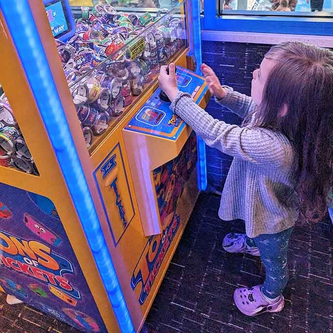 The claw machine tempts young gamblers with prizes, teaching valuable lessons about probability and the occasional miraculous victory.