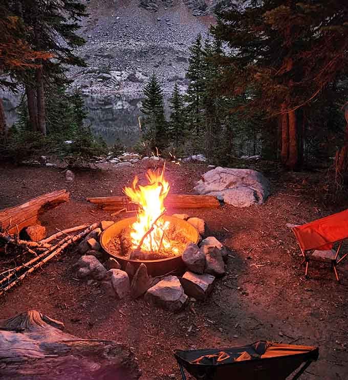 Nothing says "you've made it" quite like a crackling campfire with an alpine lake view that beats any screensaver ever created.