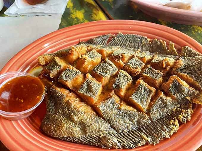 That golden-fried flounder scored in a crosshatch pattern is basically edible art that tastes even better than it looks.