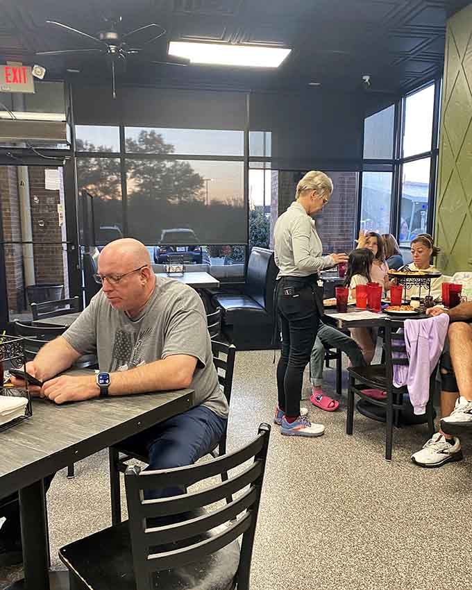 Spacious dining room with big windows means everyone outside can watch you tackle pizzas larger than their ambitions.