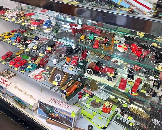 Miniature cars parade across the shelves, representing decades of childhood dreams now perfectly preserved in metal and paint.