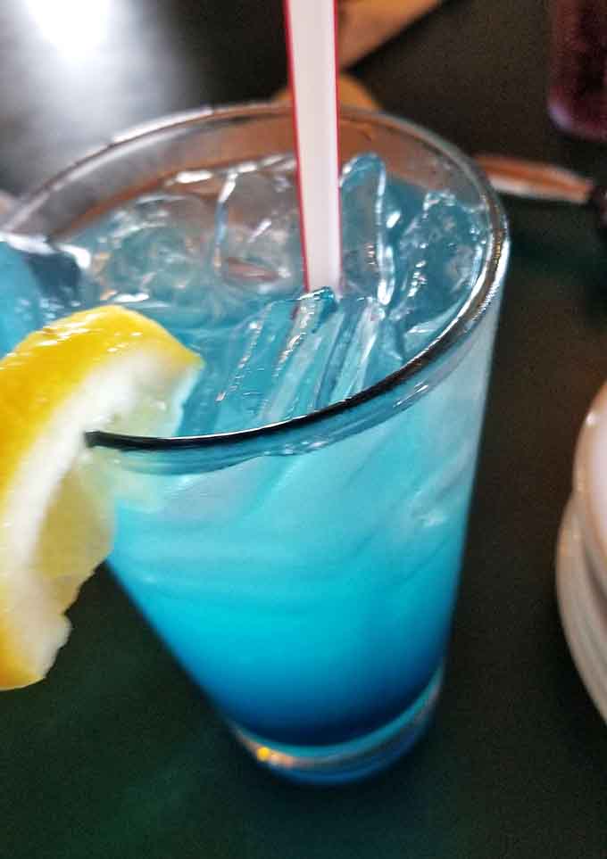That electric blue drink looks like liquid summer sky, probably tastes better, and definitely makes Monday more interesting.
