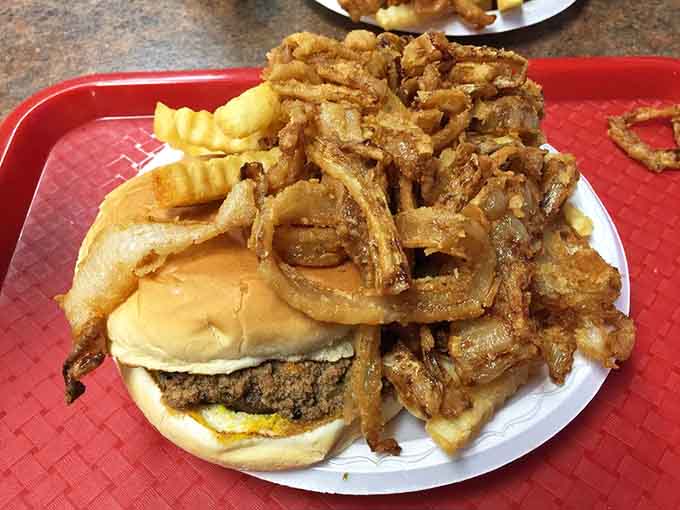 Chili, cheese, and beef unite in glorious harmony while onion rings cascade like delicious waterfalls around the plate's edges.