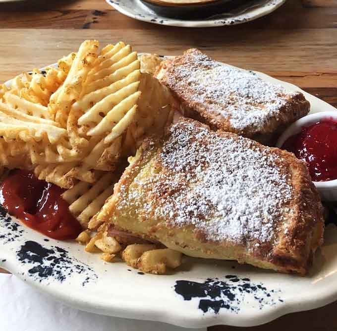 The Monte Cristo arrives dusted with powdered sugar, sweet and savory dancing together like old friends.