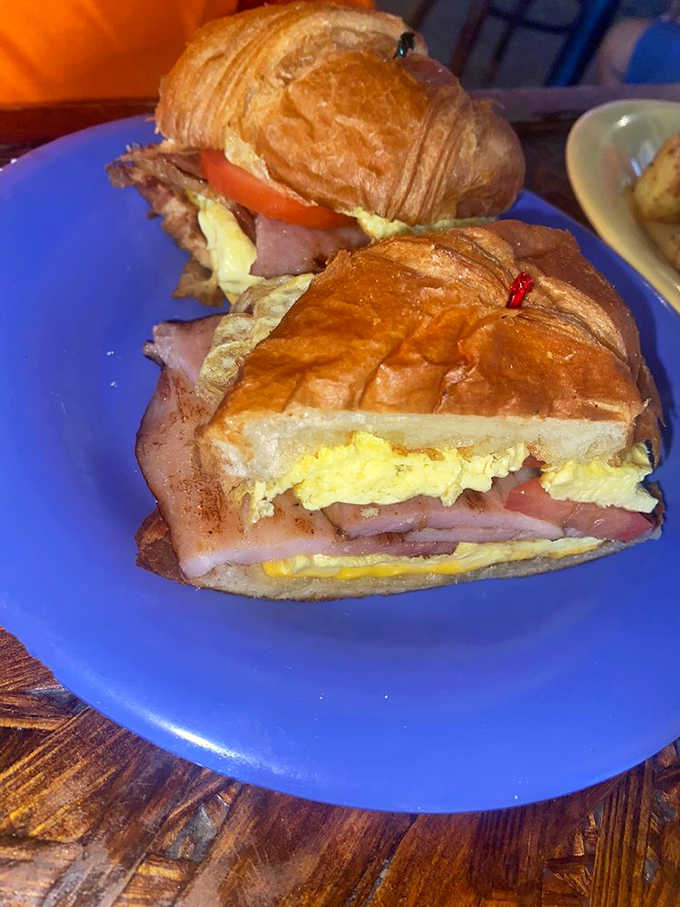 Croissant sandwiches stuffed with eggs and ham, proving that French pastry makes everything better, even at 8 AM.